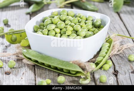 Fresh harvested peas on a wooden vintage cutting board on a table Stock ...