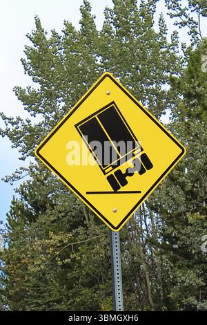 A truckers warning sign about tipping hazards Stock Photo - Alamy