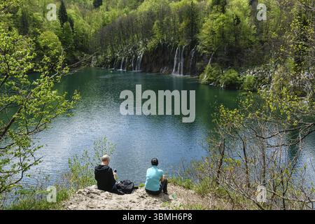 Tourists enjoy at the Plitvice Lakes National Park in Croatia, on ...