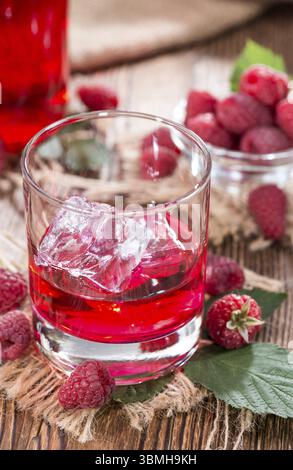 Raspberry Liqueur with some fresh fruits in a glass Stock Photo - Alamy