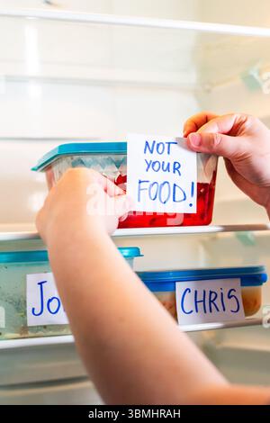 Office fridge with angry Do Not Touch My Food stickers on meal ...