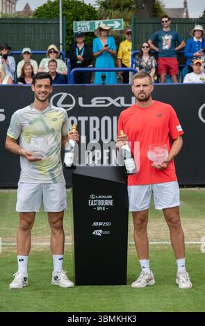 Julian Cash (L) and Lloyd Glasspool of Great Britain are seen during ...