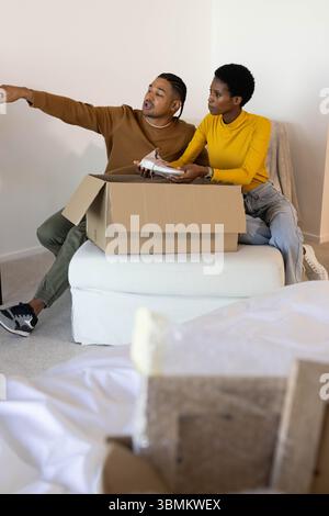 Cardboard box with blue sneakers on pink background Stock Photo - Alamy
