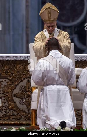 Pope Leo XIV blesses a new born as he arrives for his weekly general ...