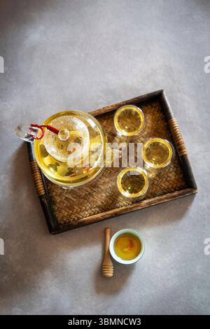 Pouring chrysanthemum tea into glass on the white table Stock Photo - Alamy