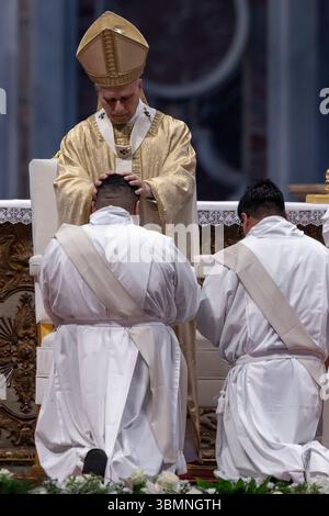 Pope Leo XIV blesses a new born as he arrives for his weekly general ...