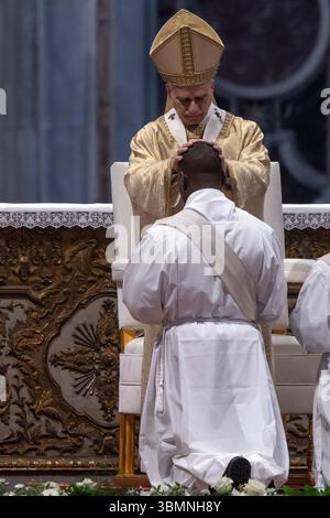 Pope Leo XIV blesses a new born as he arrives for his weekly general ...