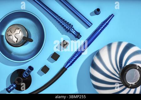 Parts of blue decorated hookah or shisha on light blue backgroun Stock ...