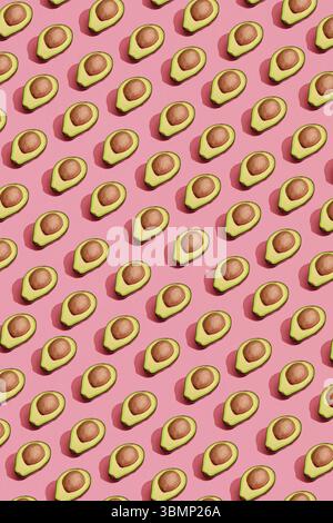 Colorful fruit pattern of fresh cutted avocado halves with pits on ...