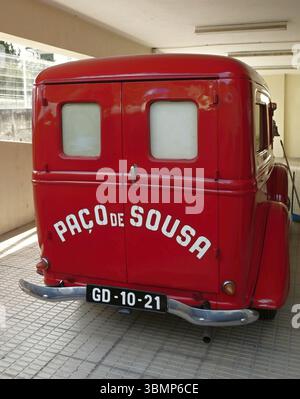 Shiny red vintage Paco de Sousa van with a siren parked indoors Stock ...