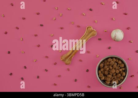 Dog snacks, dog chews, dog bone, ball toy for dog on a pink background ...