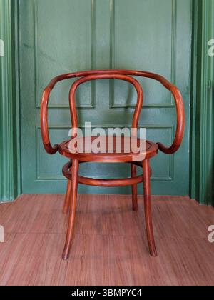 Brown chairs on wooden frame in a casual space Stock Photo - Alamy