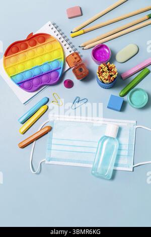 School supplies, poppit anti-stress, face mask, bottle of sanitizer ...