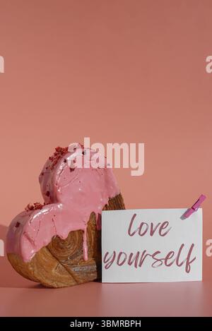 Heart shaped strawberry berry croissant on pink background with copy ...