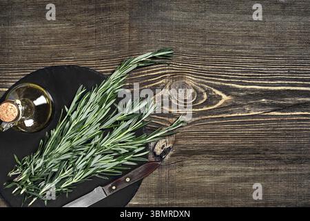 Branches of fresh rosemary on a gray concrete background. Copy space ...