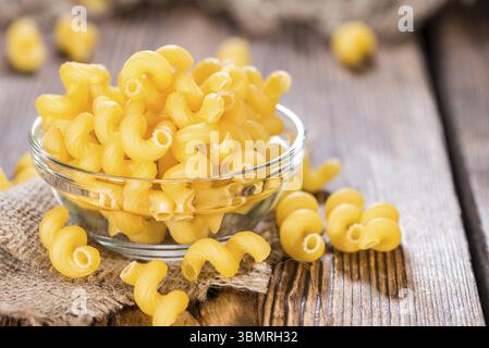 Pasta Curls (close-up shot) on dark wooden background Stock Photo - Alamy