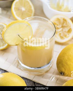 Fresh made Juice (lemon) on an old and rustic wooden table (selective ...