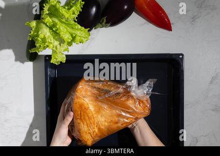 A man holds fresh pork meat during traditional Slavonian pig slaugher ...