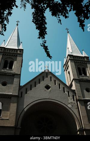 A dramatic close-up of the symmetrical twin spires of the Subotica ...