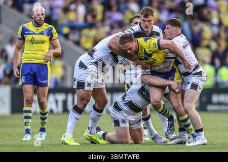 Ben Currie of Warrington Wolves is tackled during the Betfred Super ...