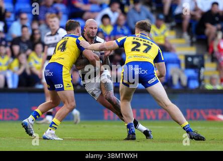 Luke Thomas of Warrington Wolves is tackled during the Betfred Super ...