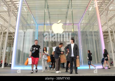 People exit an Apple store on Fifth Avenue in Manhattan, New York City ...