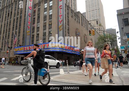 People walk past Radio City Music Hall in Manhattan, New York City ...