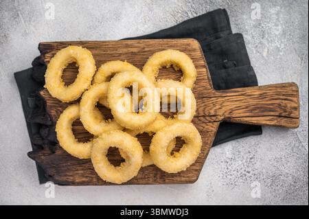 Raw and frozen squid rings with breading, uncooked calamari snack ...