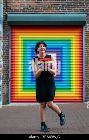 Young urban woman standing and posing, studio shot Stock Photo - Alamy