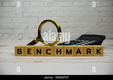 Benchmark with wooden blocks alphabet letters and magnifying glass ...