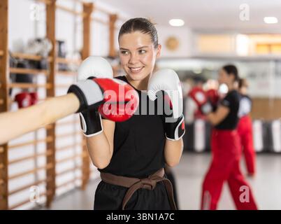 Women fight with hands, using all strength, courage during boxing ...