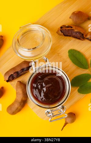 Jar with tasty tamarind jam with fruits on white background Stock Photo ...