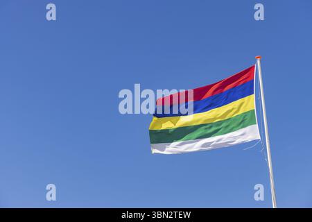 Waving flag of Terschelling in front of a blue sky at Wadden island ...
