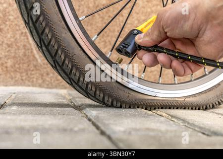 Flat tire on electric bike, pumping air into bike inner tube, bike ...