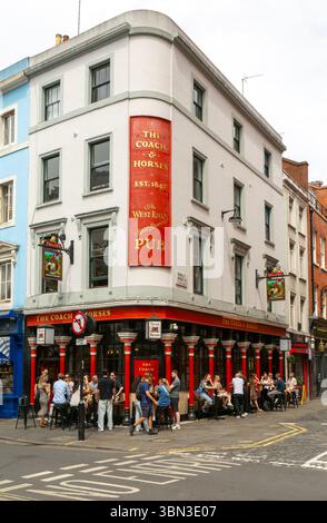 People sitting outside The Coach and Horses pub, Romilly Street, Soho ...