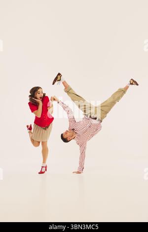 Energetic couple performing retro lindy hop dance in vibrant vintage ...