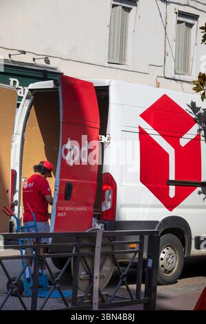 DPD delivery driver man person courier and van delivering goods in the ...