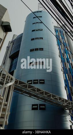 A modern building facade with metallic grid patterns beneath a clear ...