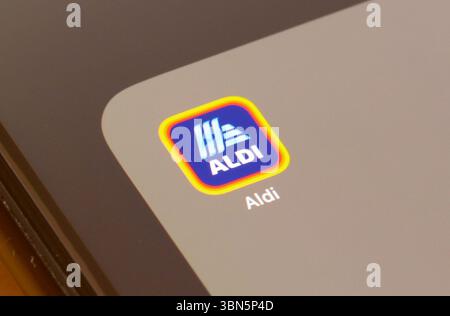 Aldi supermarket app on smartphone screen with a Mastercard to make ...
