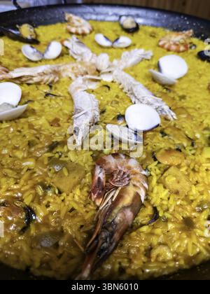 Traditional seafood paella in the fry pan on a wooden old table Stock ...