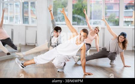 Young guy practicing breakdance floor-works in training hall Stock ...