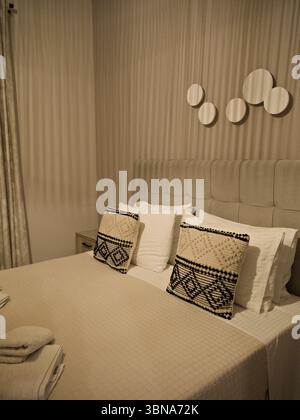 Modern bedroom in beige colors, interior design. Soft selective focus ...