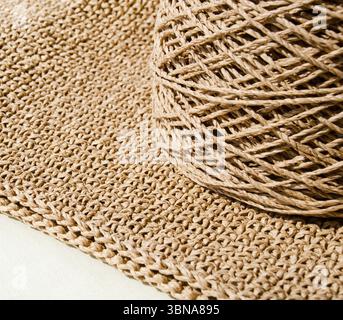 Knitted bag with beach accessories on yellow background. Space for text ...