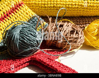 Knitted bag with beach accessories on yellow background. Space for text ...