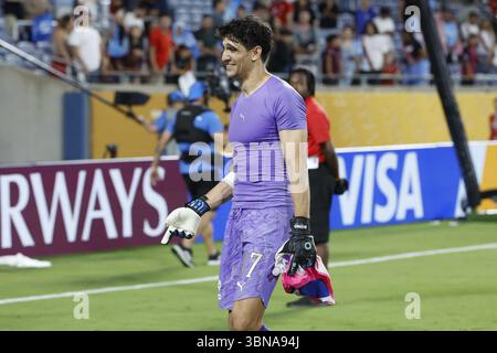 Al-Hilal goalkeeper Yassine Bounou, right, keeps the ball away from ...