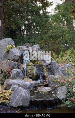 Small waterfall cascading over dark rocks in Ordesa y Monte Perdido ...