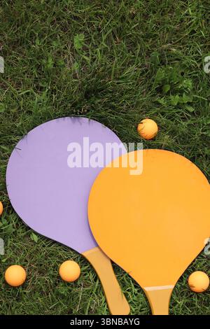 Top view of tennis rackets and ball on green background. Horizontal ...