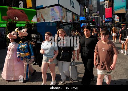 People walk in Times Square, Manhattan, New York City. (Photo by Jimin ...