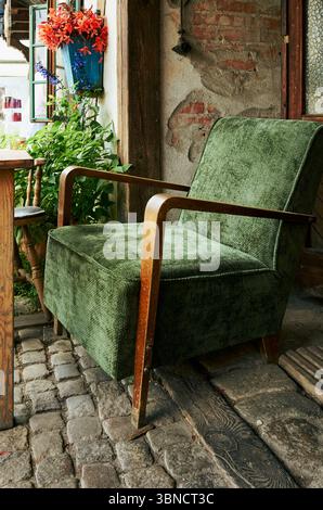 Comfortable sofa and armchair placed on soft carpet near windows in ...