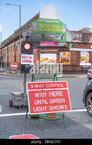 Temporary three-way traffic control system out of order at a busy town ...
